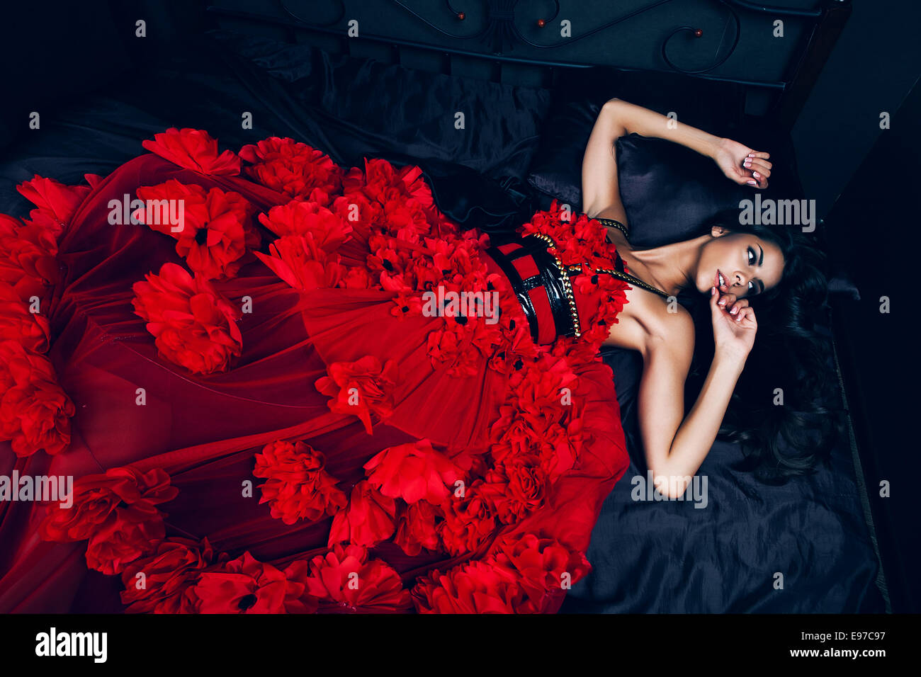 Beautiful woman in red dress on red background Stock Photo - Alamy