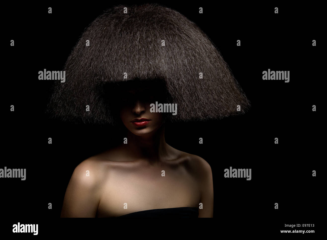 Woman with creative hairstyle on black background Stock Photo - Alamy