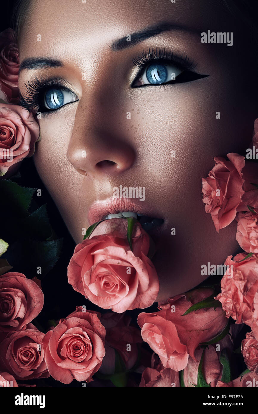 woman with pink rose in mouth Stock Photo - Alamy