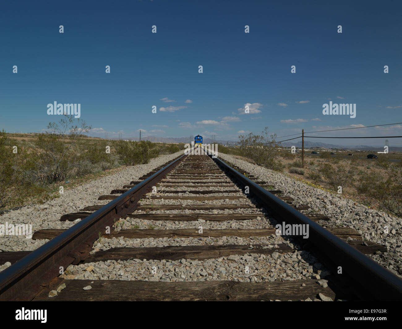 Country side rail track with train on blue sky background Stock Photo ...