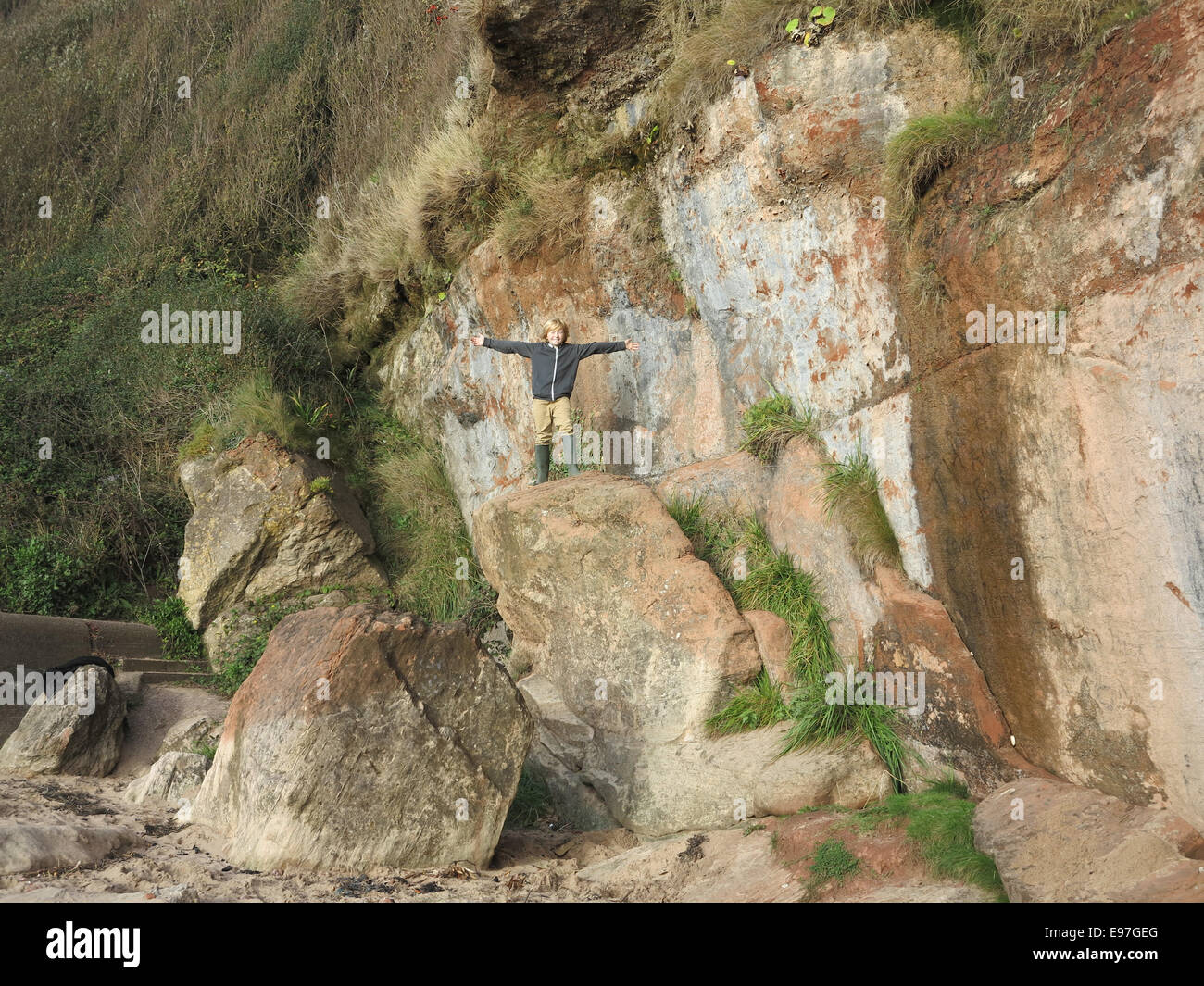 boy standing on rock Stock Photo - Alamy