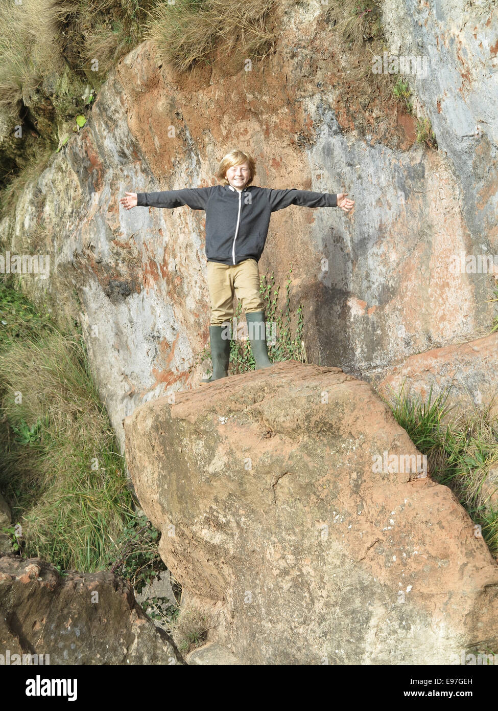 boy standing on rock Stock Photo - Alamy