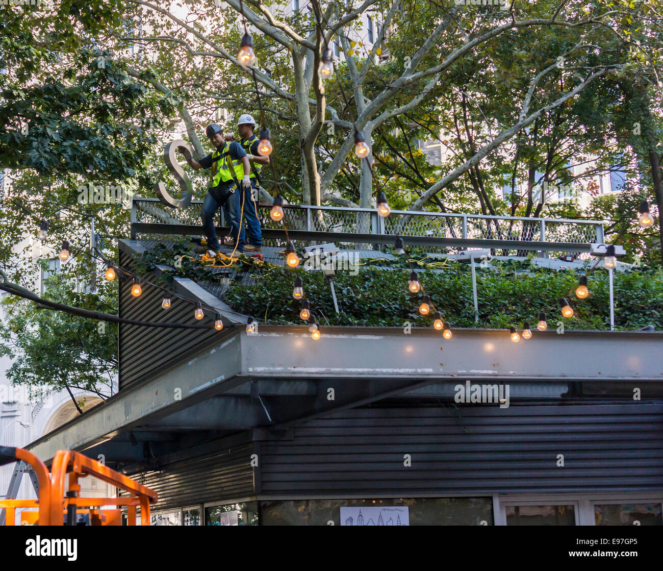 Workers waste no time removing the signage from the popular Shake Shack ...