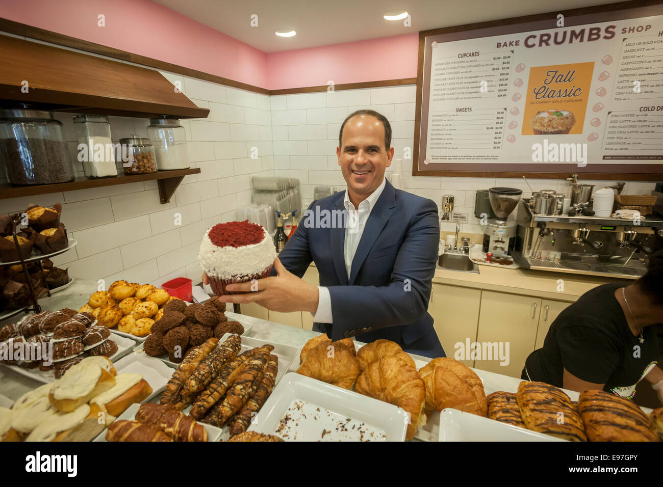Co-owner Marcus Lemonis poses with a giant cupcake in the Crumbs Bake ...
