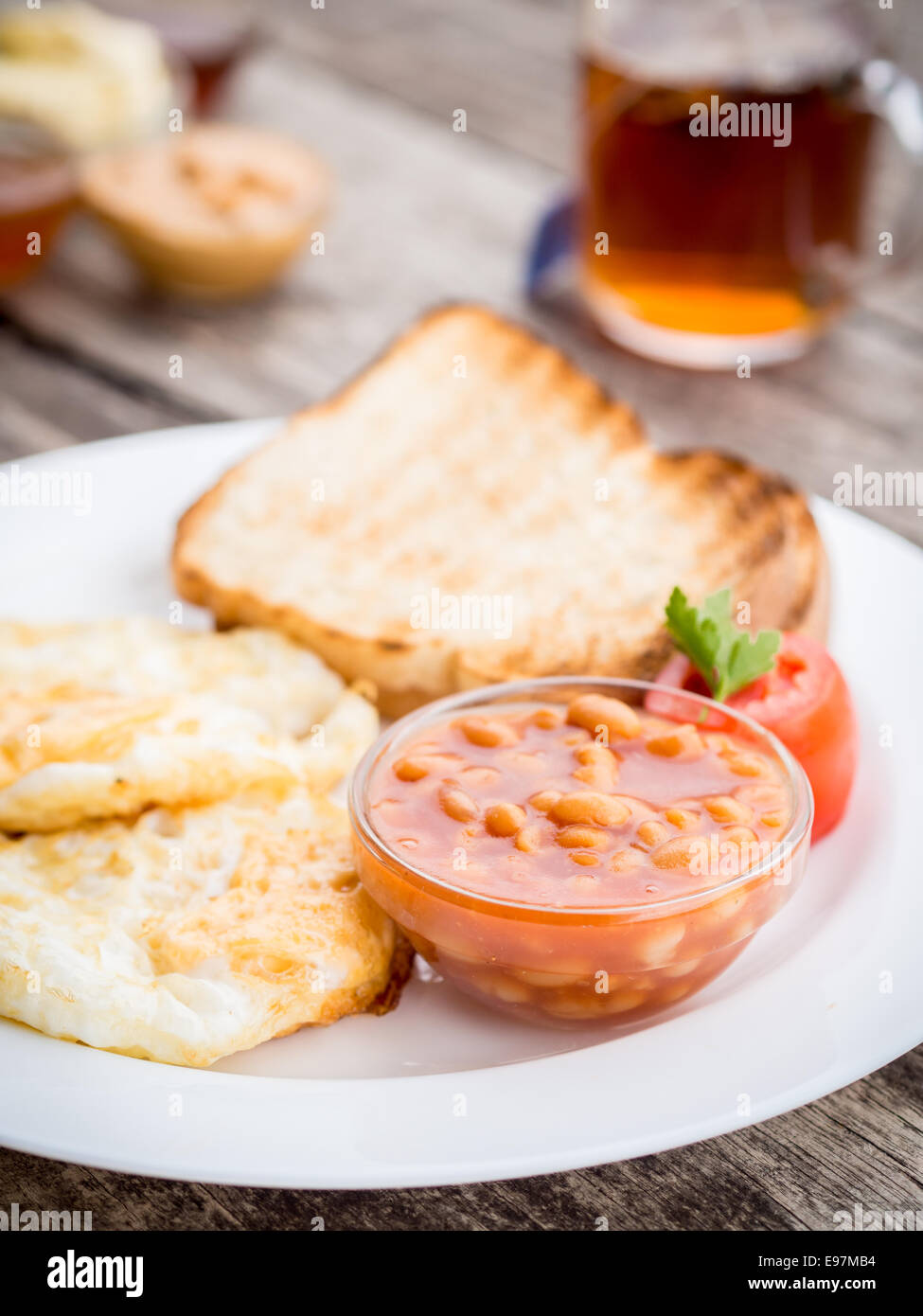 English breakfast: toasts, eggs, beans, jam and honey Stock Photo - Alamy