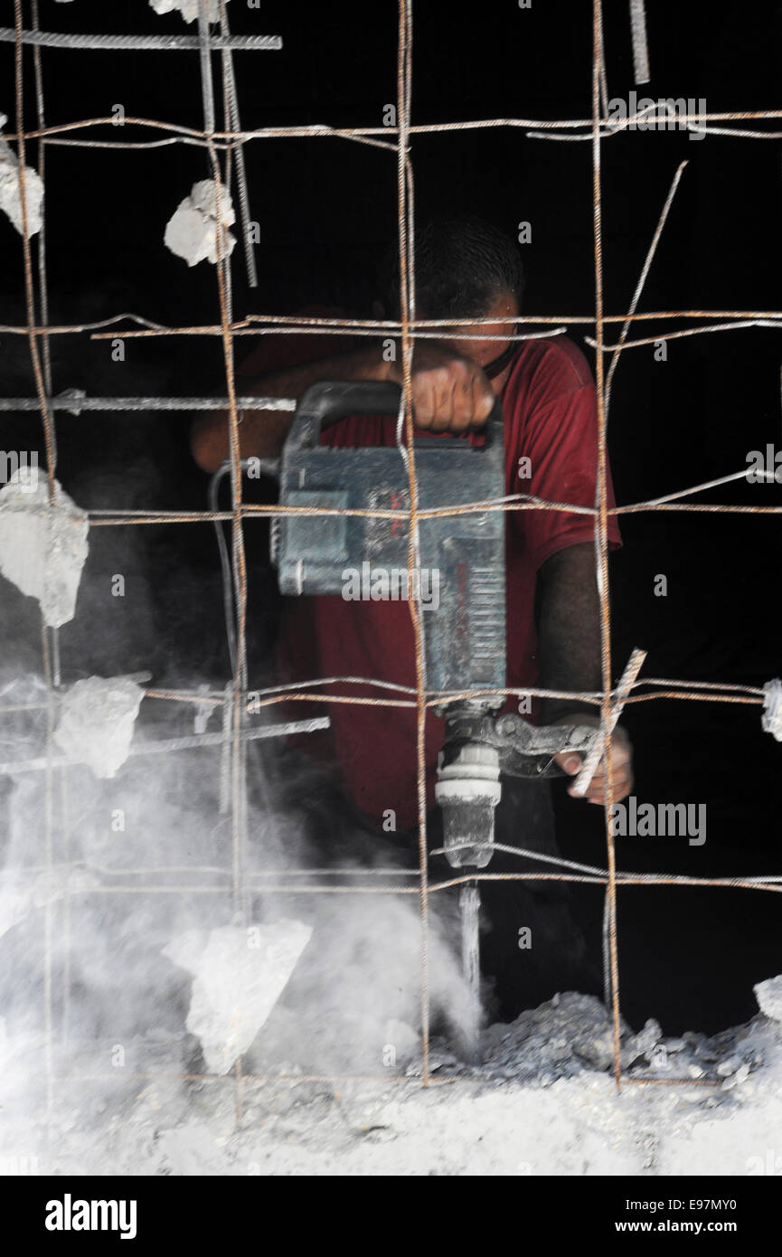 Construction worker uses a Jackhammer to break through concrete Stock ...