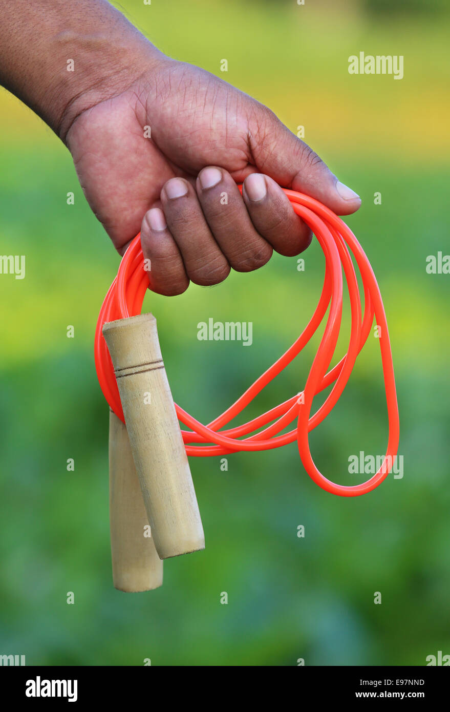 Hand holding a skipping rope Stock Photo - Alamy