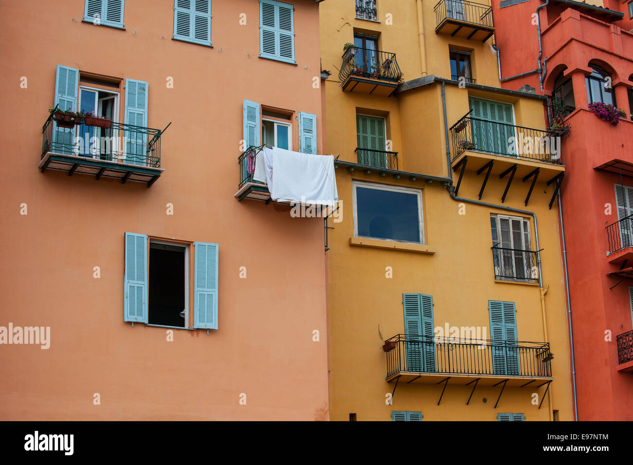 Balconies and windows with sunblinds of pastel coloured houses in the ...