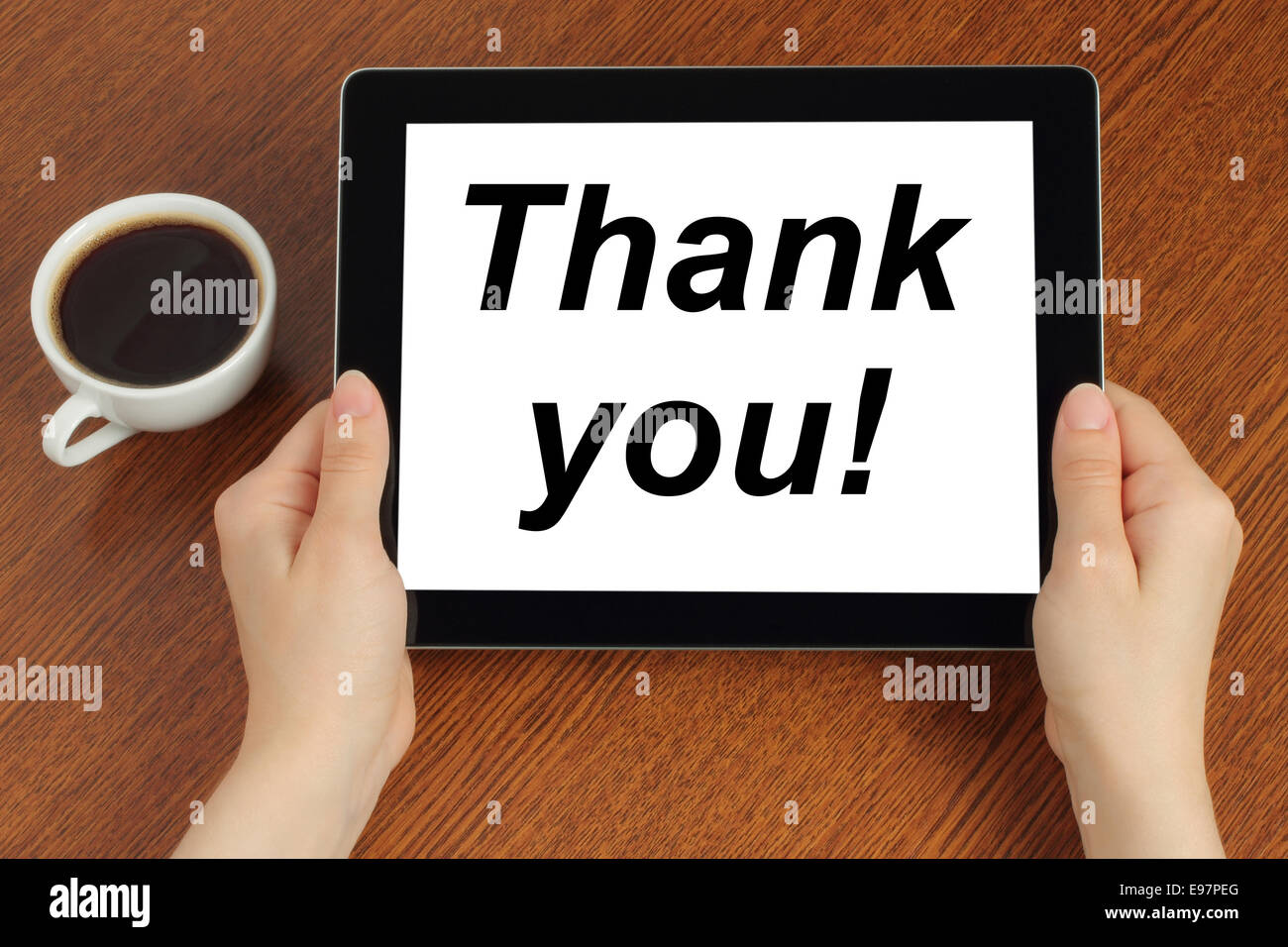 Hands hold tablet PC with "thank you" text on wooden background Stock ...