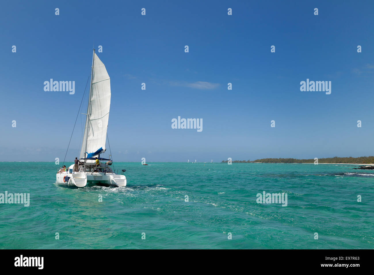 A catamaran sailing in the Indian Ocean off the coast of Mauritius ...