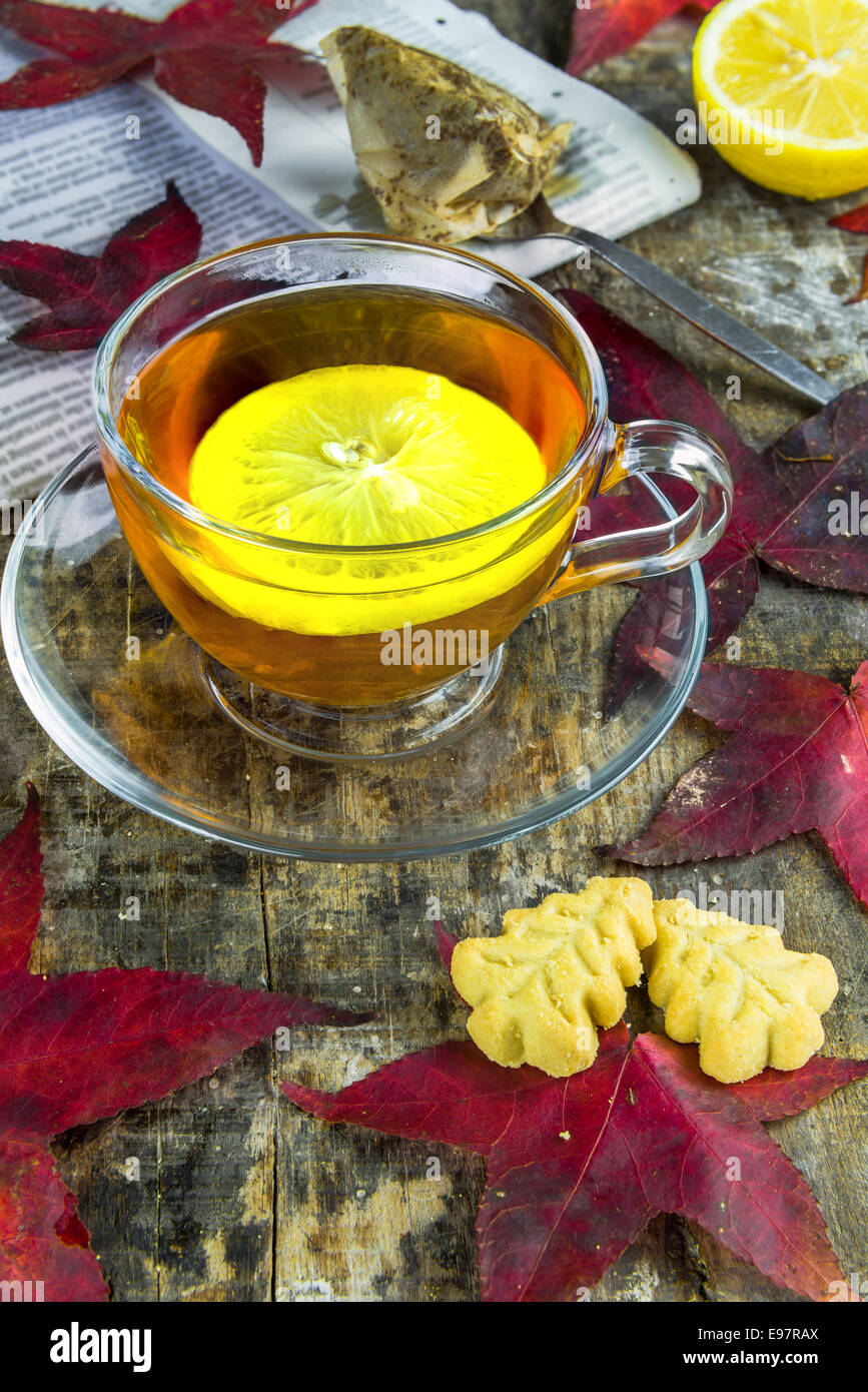 A cup of tea with lemon on old rustic wooden table Stock Photo - Alamy