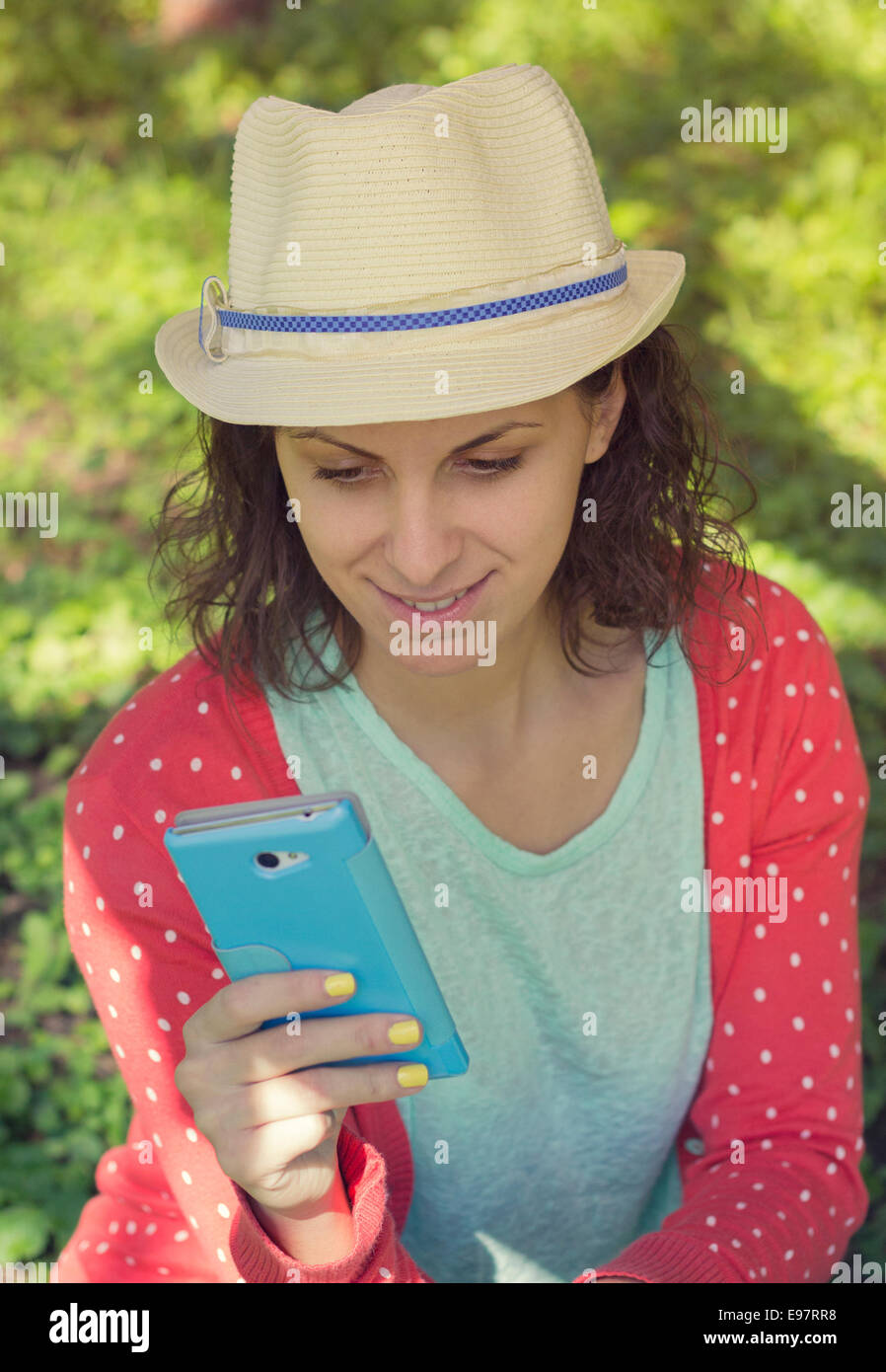 Cute hipster girl text messaging on her smart phone Stock Photo - Alamy