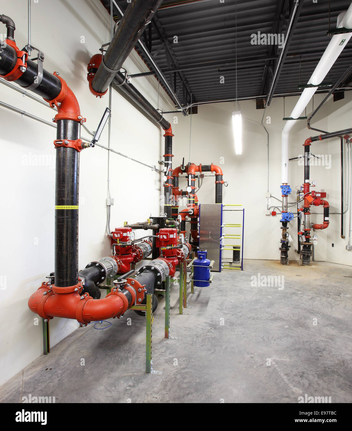 The mechanical room of a geothermal energy heated building Stock Photo ...