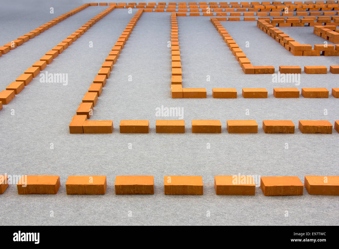 Red labyrinth, composed of many bricks on a gray floor Stock Photo - Alamy
