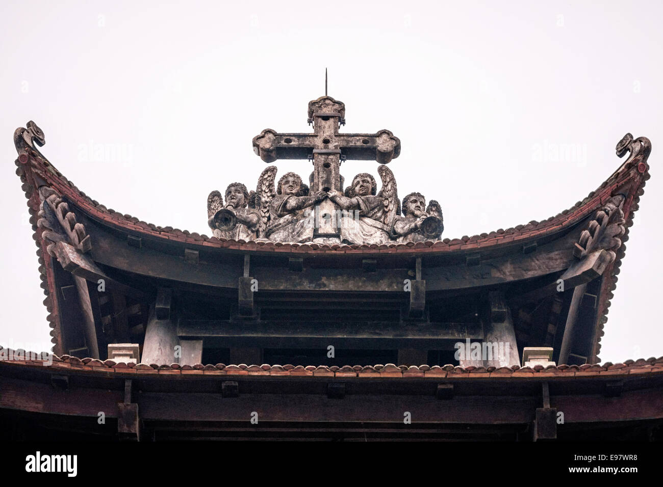 Angels holding cross on top of bell tower in Vietnam Stock Photo - Alamy