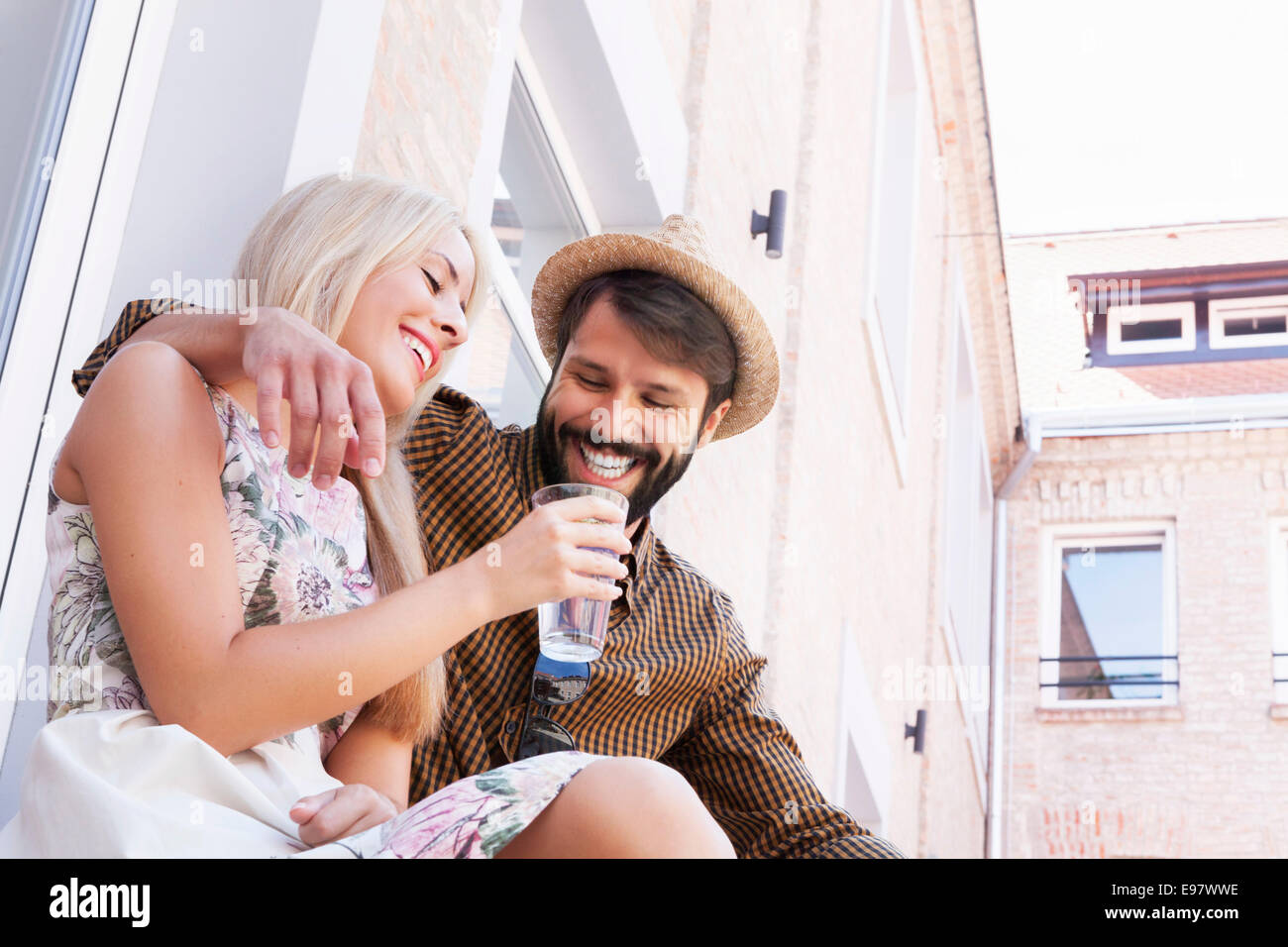 Happy young couple drinking a mineral water together Stock Photo - Alamy