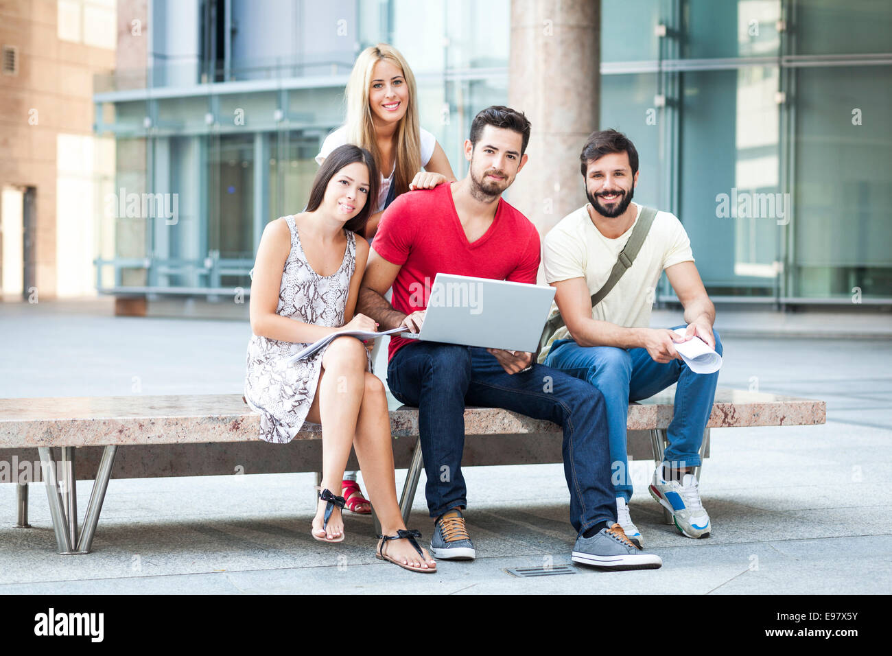 Group of university students with laptop on campus Stock Photo - Alamy