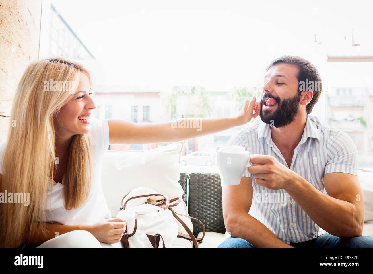 Young couple in cafe fooling around Stock Photo - Alamy