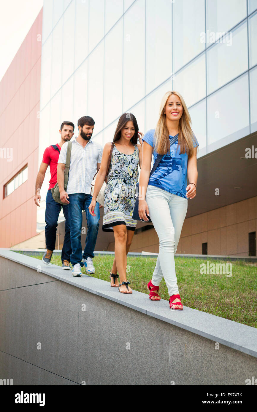Group of university students walking in a row Stock Photo - Alamy