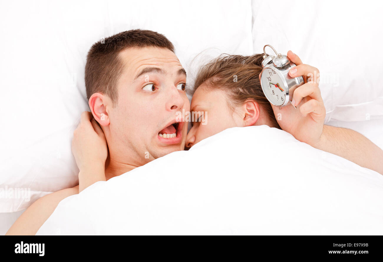 Man waking up lately near a woman Stock Photo - Alamy Man waking up lately near a woman Stock Photo - Alamy