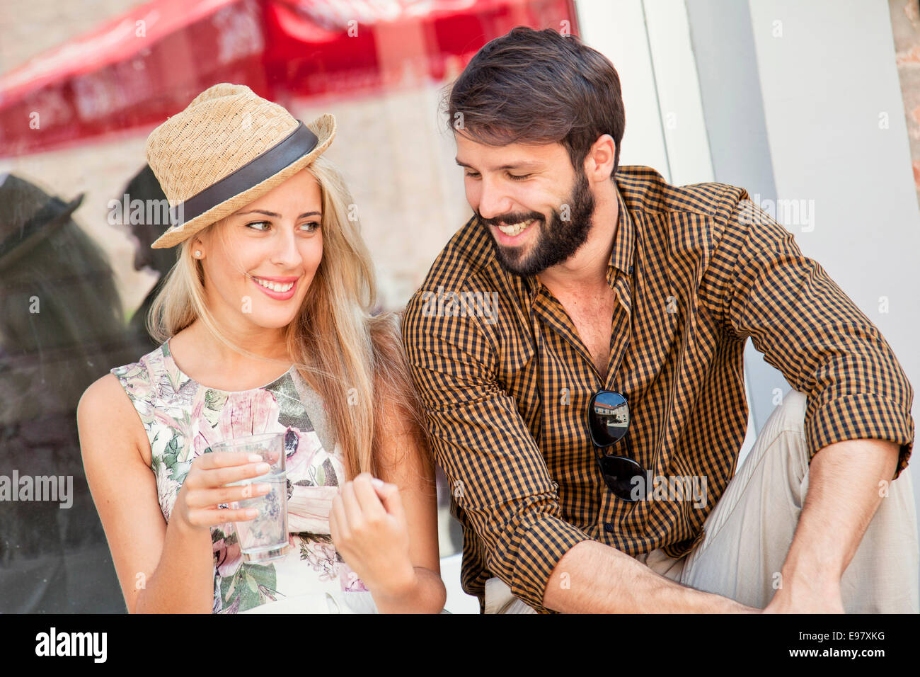 Happy young couple taking a break in town Stock Photo - Alamy