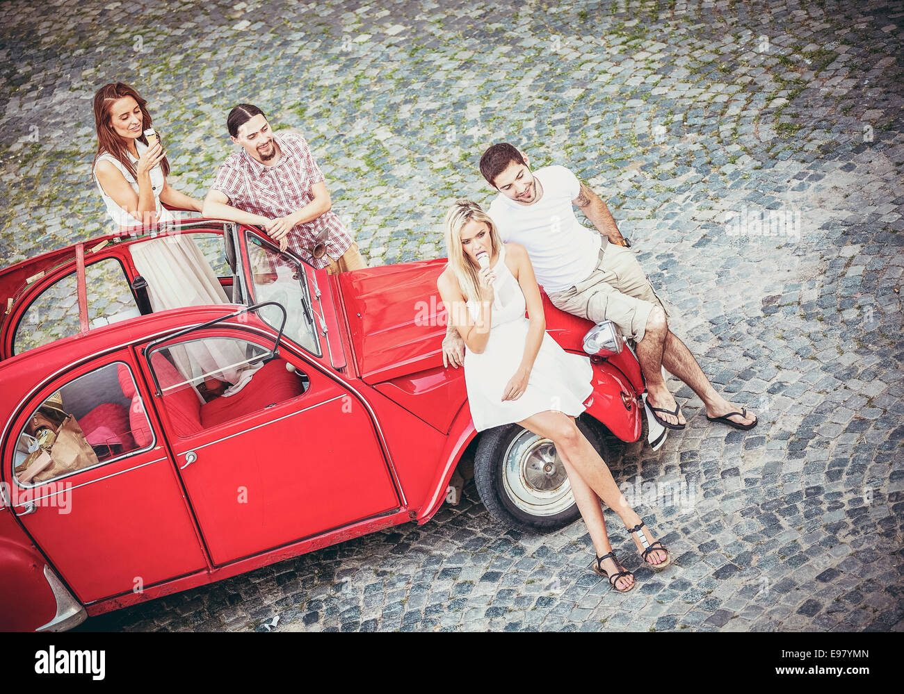 Young people taking a break on road trip Stock Photo - Alamy