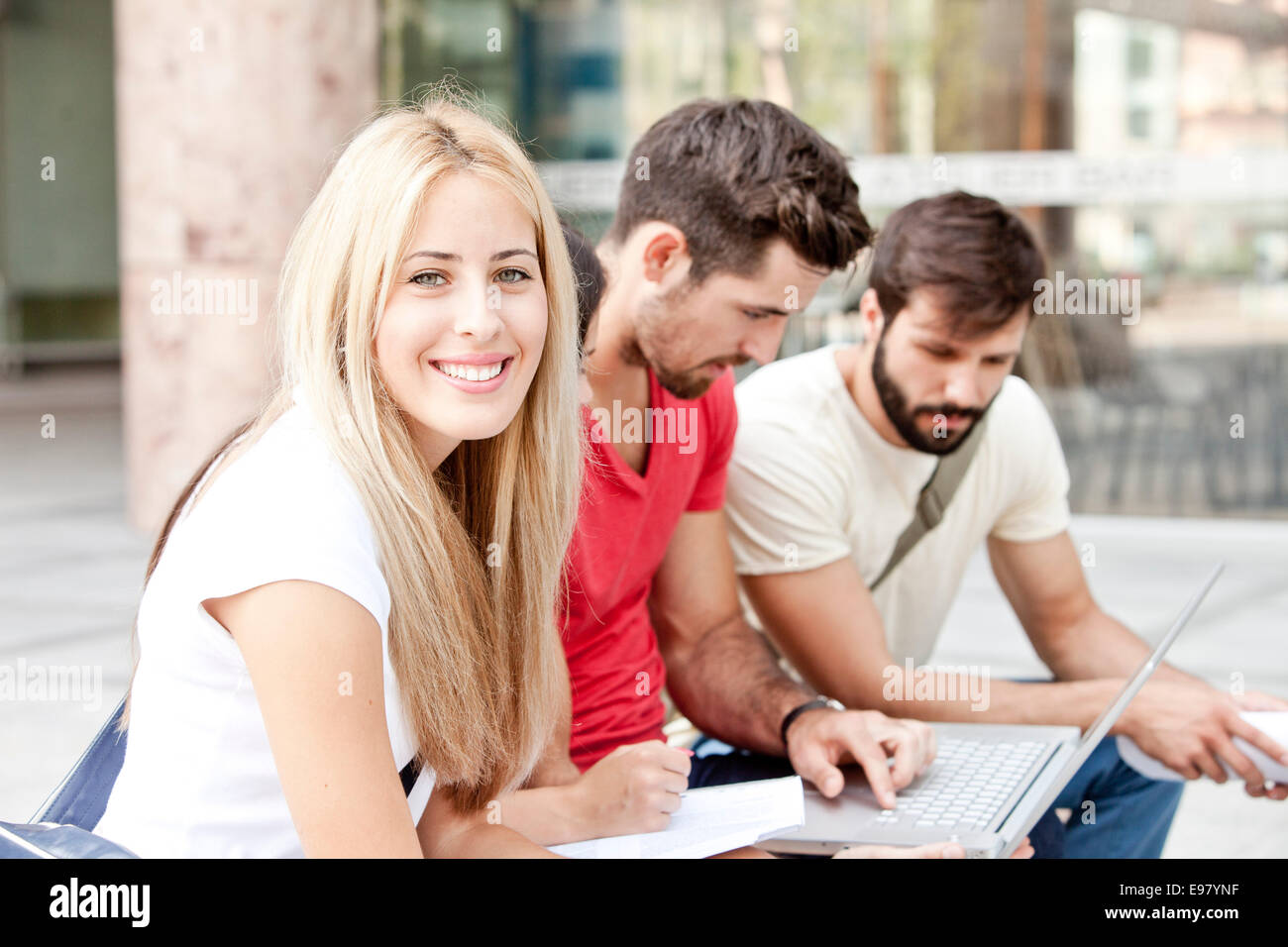 Group of university students using laptop together Stock Photo - Alamy