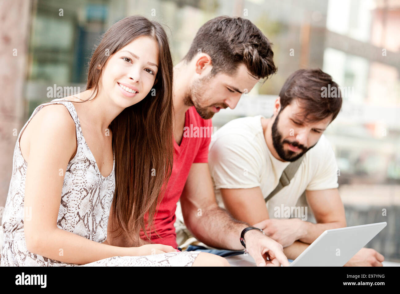 Group of university students using laptop together Stock Photo - Alamy