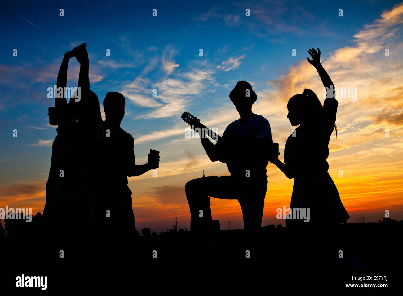 Young people dancing and having fun at sunset Stock Photo - Alamy
