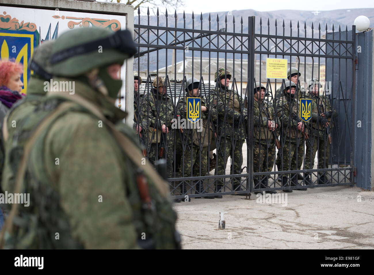 Ukrainian soldiers inside the gate of the Perevalne military base near ...