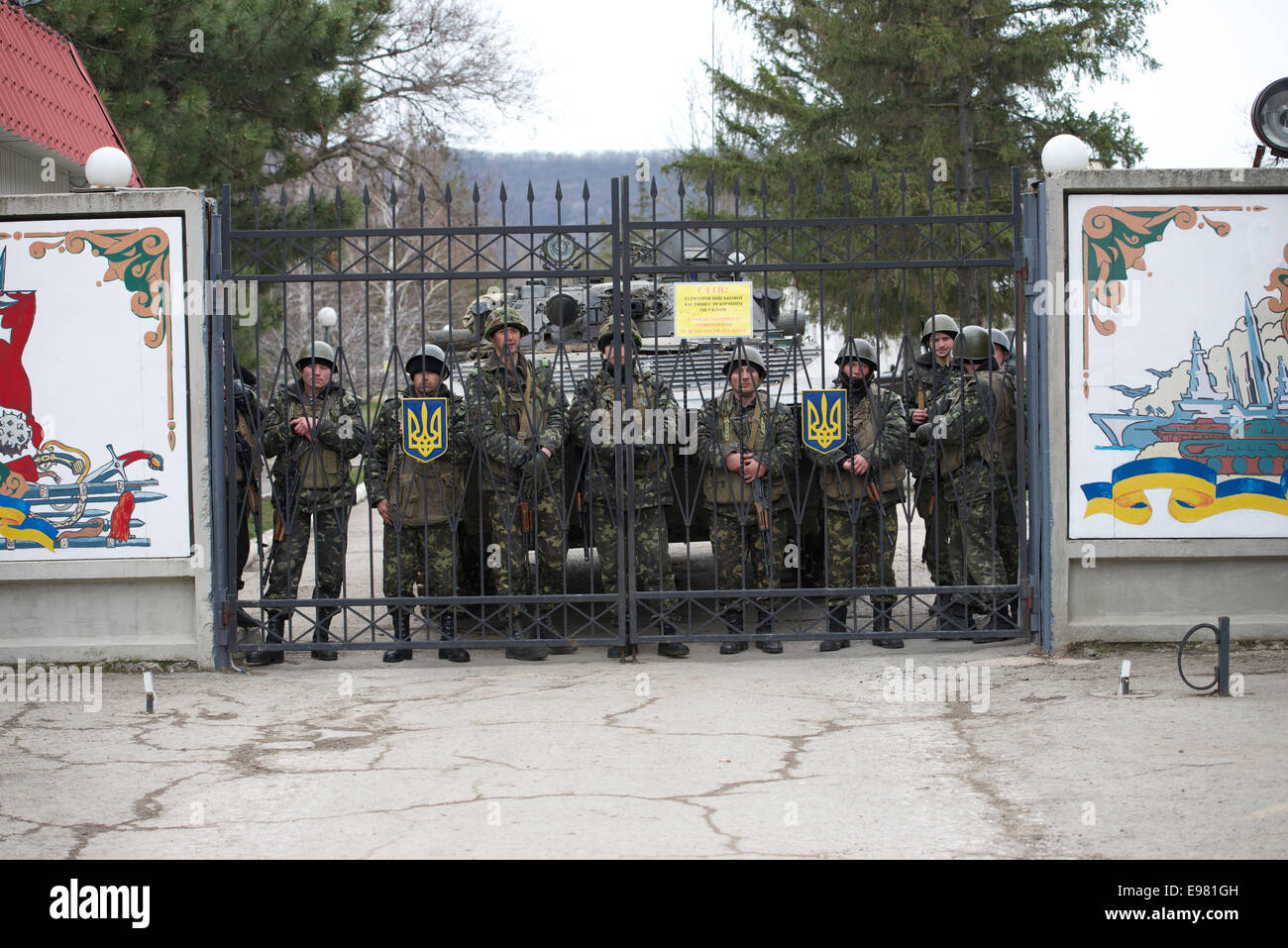 Ukrainian soldiers inside the gate of the Perevalne military base near ...