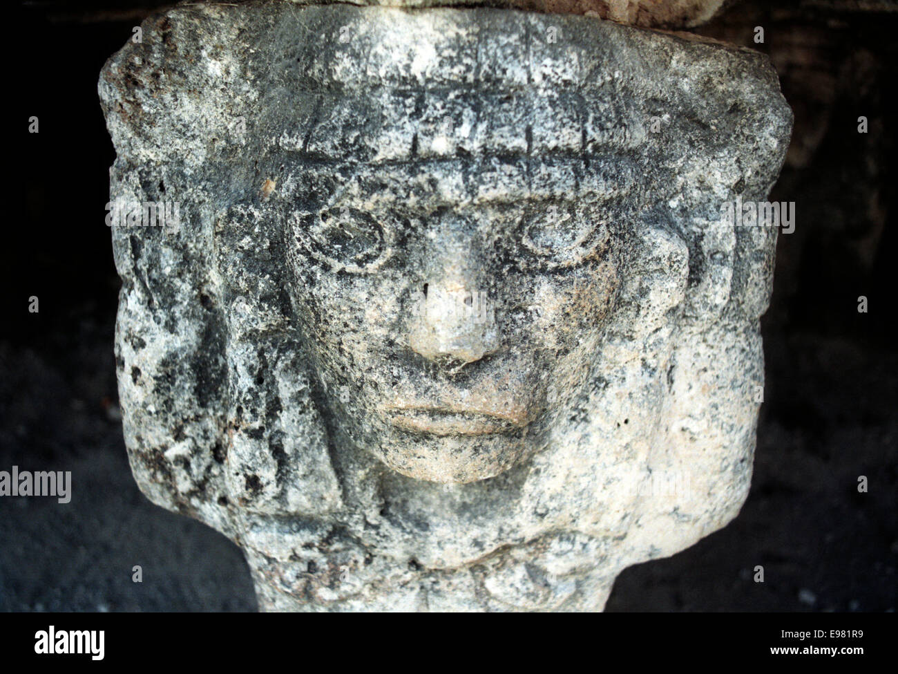 Weathered platform bearer carving at the Mayan ruins of Chichen Itza ...