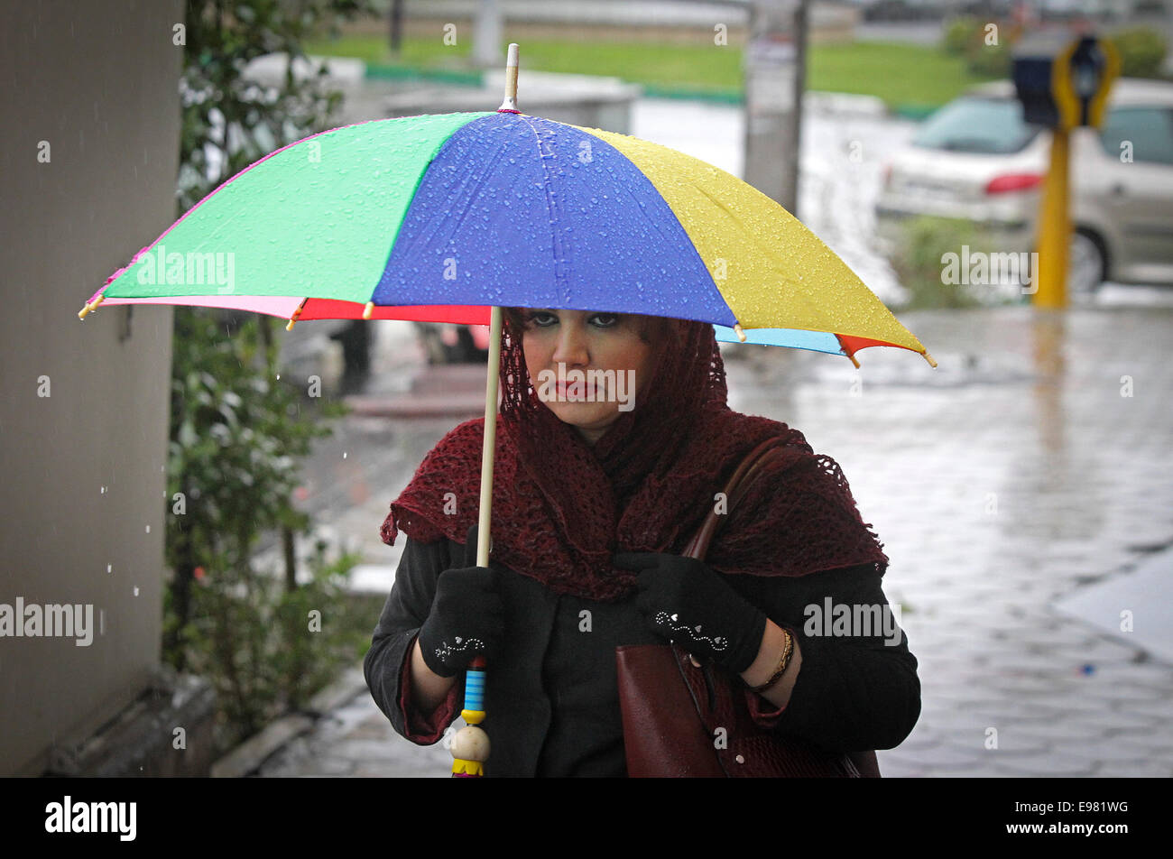 Tehran, Iran. 21st Oct, 2014. A woman walks in heavy rainfall in Tehran ...