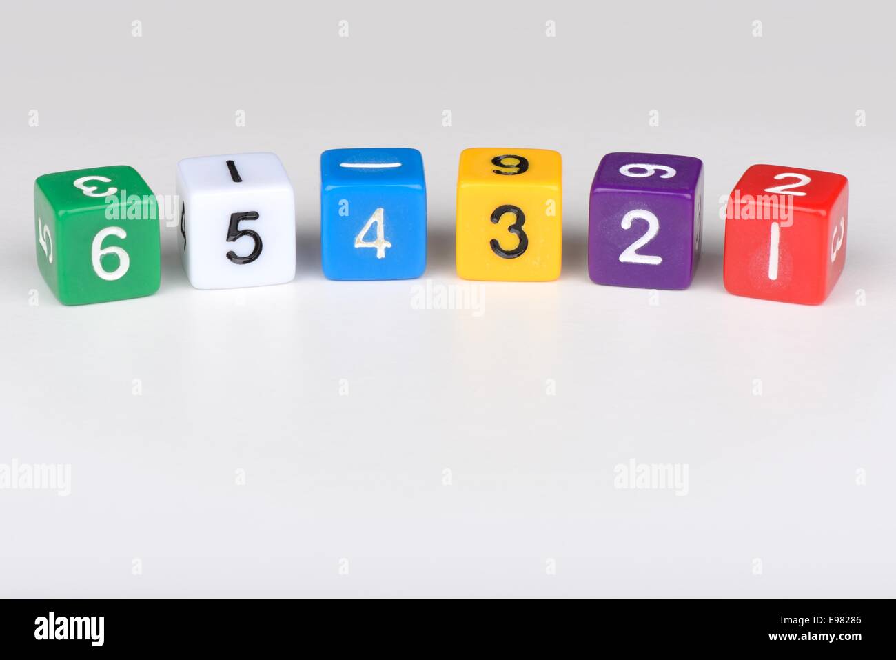 A row of coloured dice numbers six to one Stock Photo - Alamy