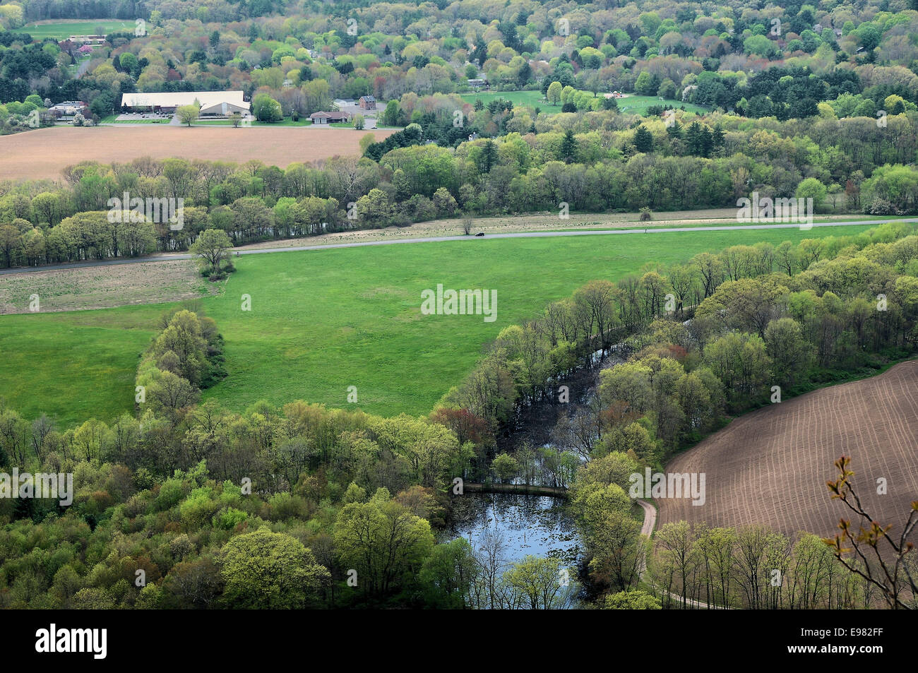 Aerial view of lush green pastures, groves of trees, plowed fields ...
