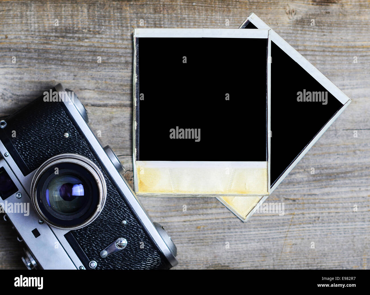 Vintage camera with blank old photograph on wooden background ...
