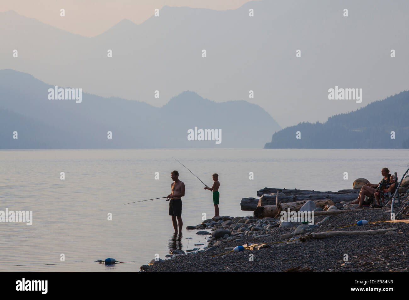 Father and son fishing on Slocan Lake, New Denver, Slocan Valley, West ...