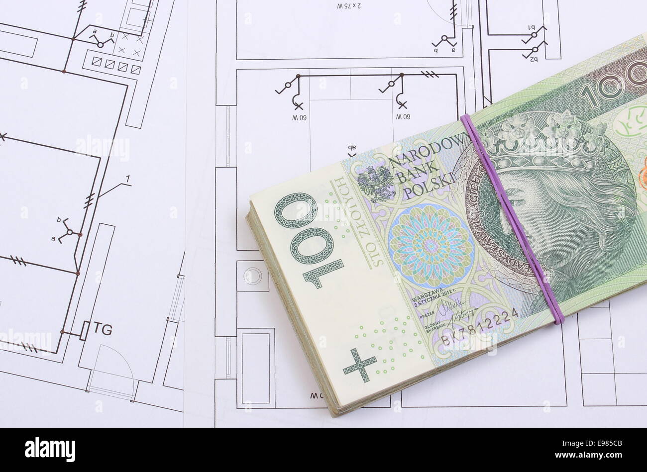 Heap of banknotes lying on construction drawing of house, concept of ...