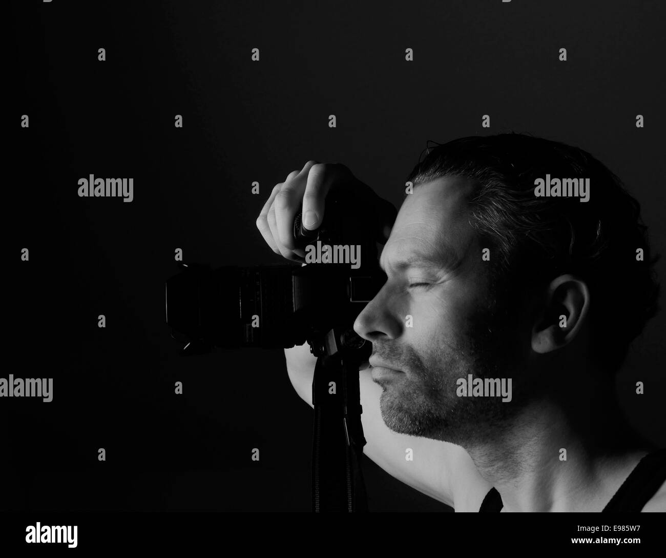 Photographer on a dark background Stock Photo - Alamy