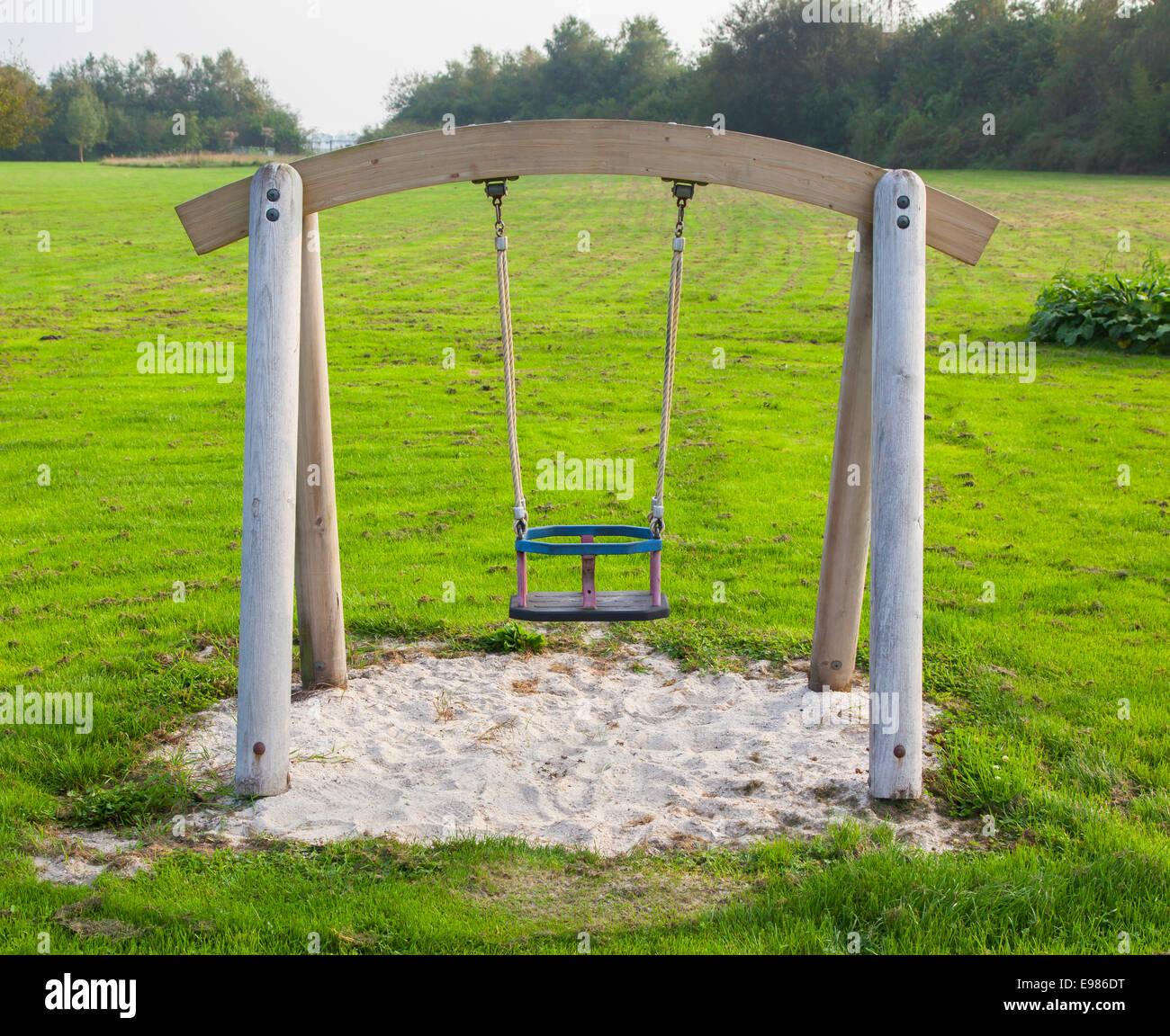Swing in a park, playground for kids Stock Photo - Alamy