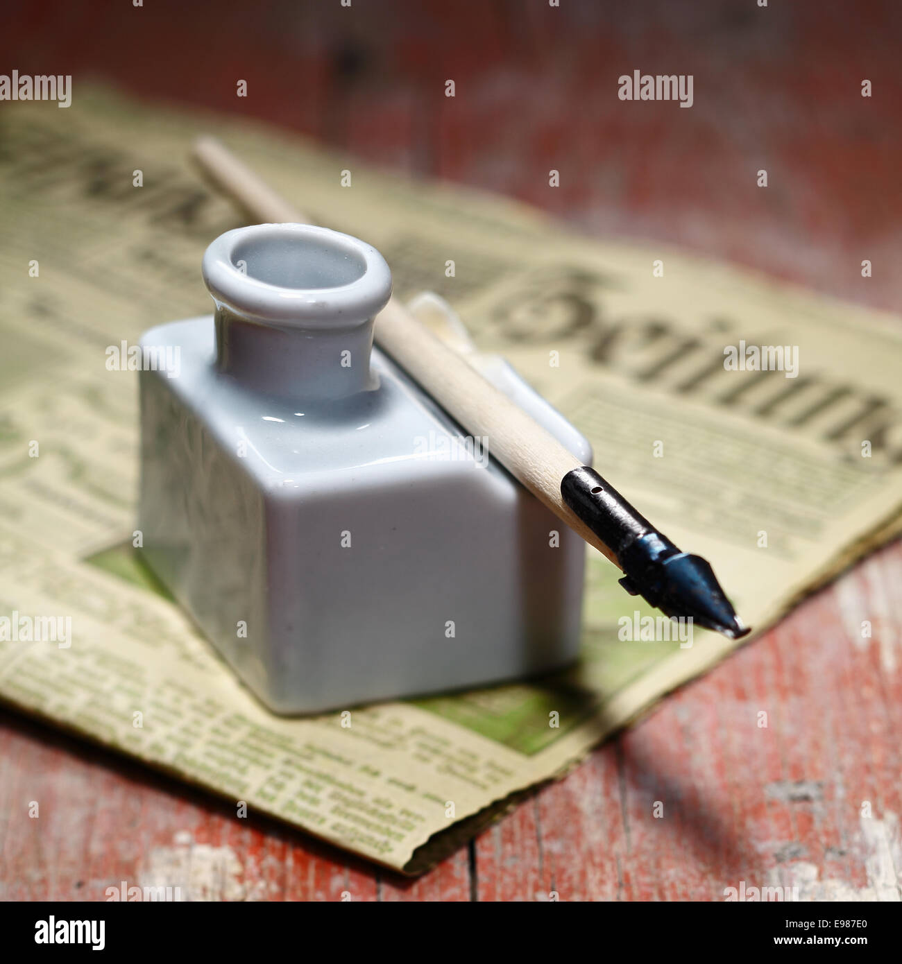 Old Ink Quill and an antique newspaper on an ancient wooden background ...