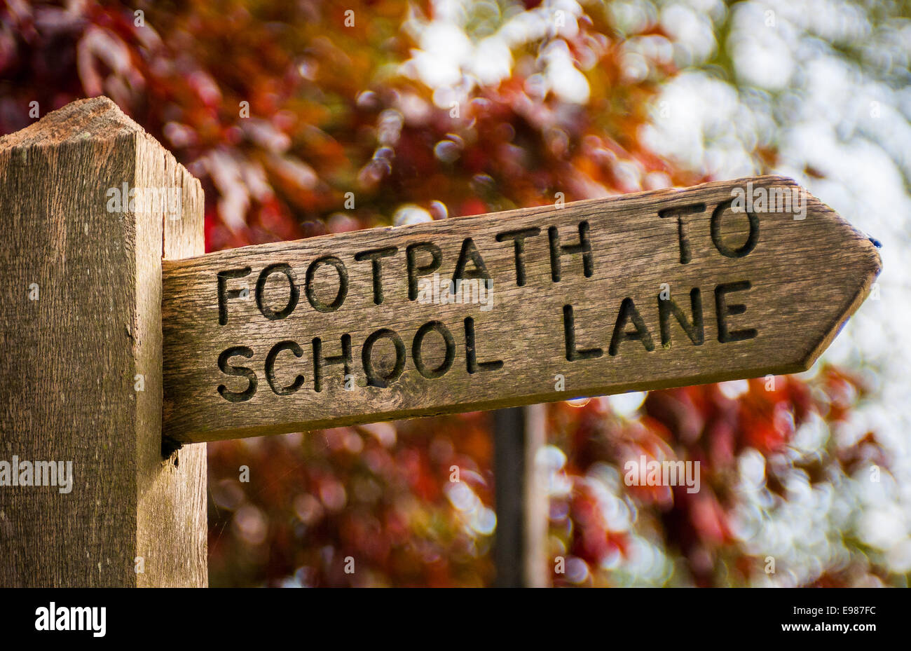 A wooden sign post points to the footpath for School Lane Stock Photo ...