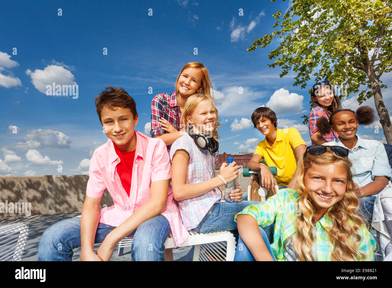 Positive multinational group of kids sit together Stock Photo - Alamy
