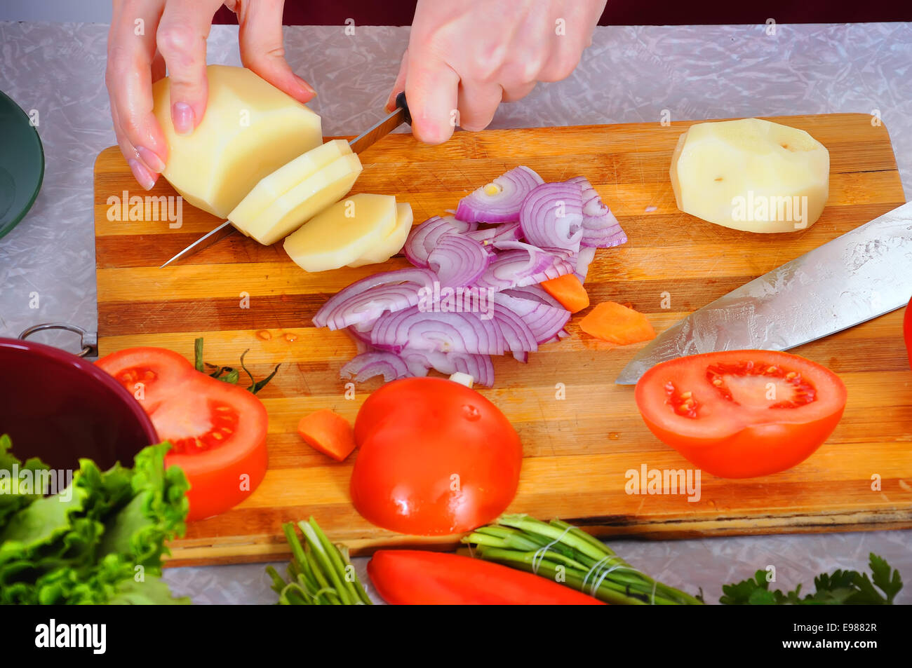 human hands cut potatoe in kitchen Stock Photo - Alamy