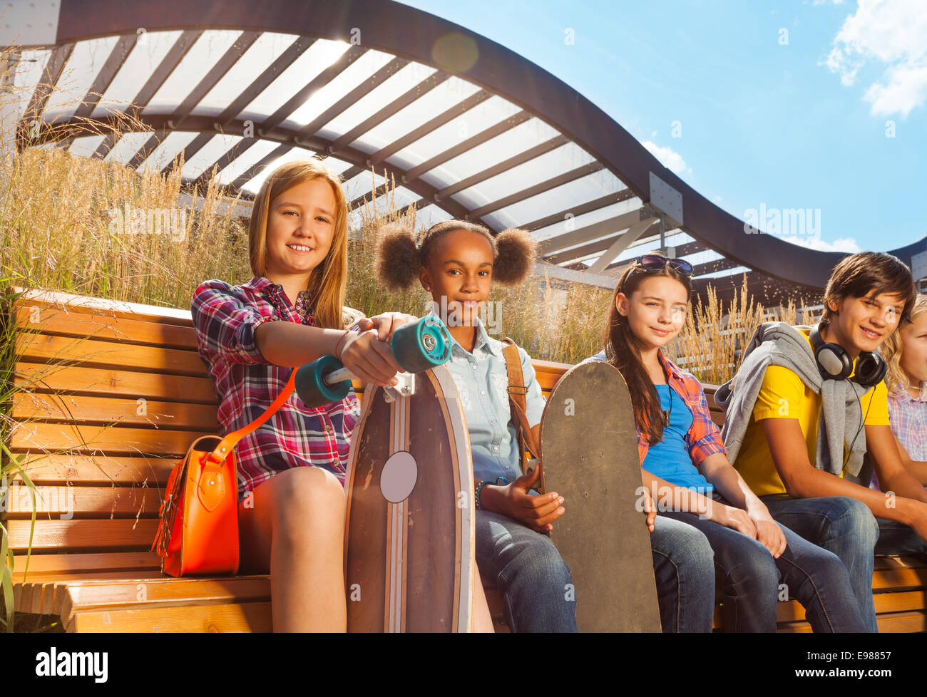 View of children who sit on wooden bench together Stock Photo - Alamy