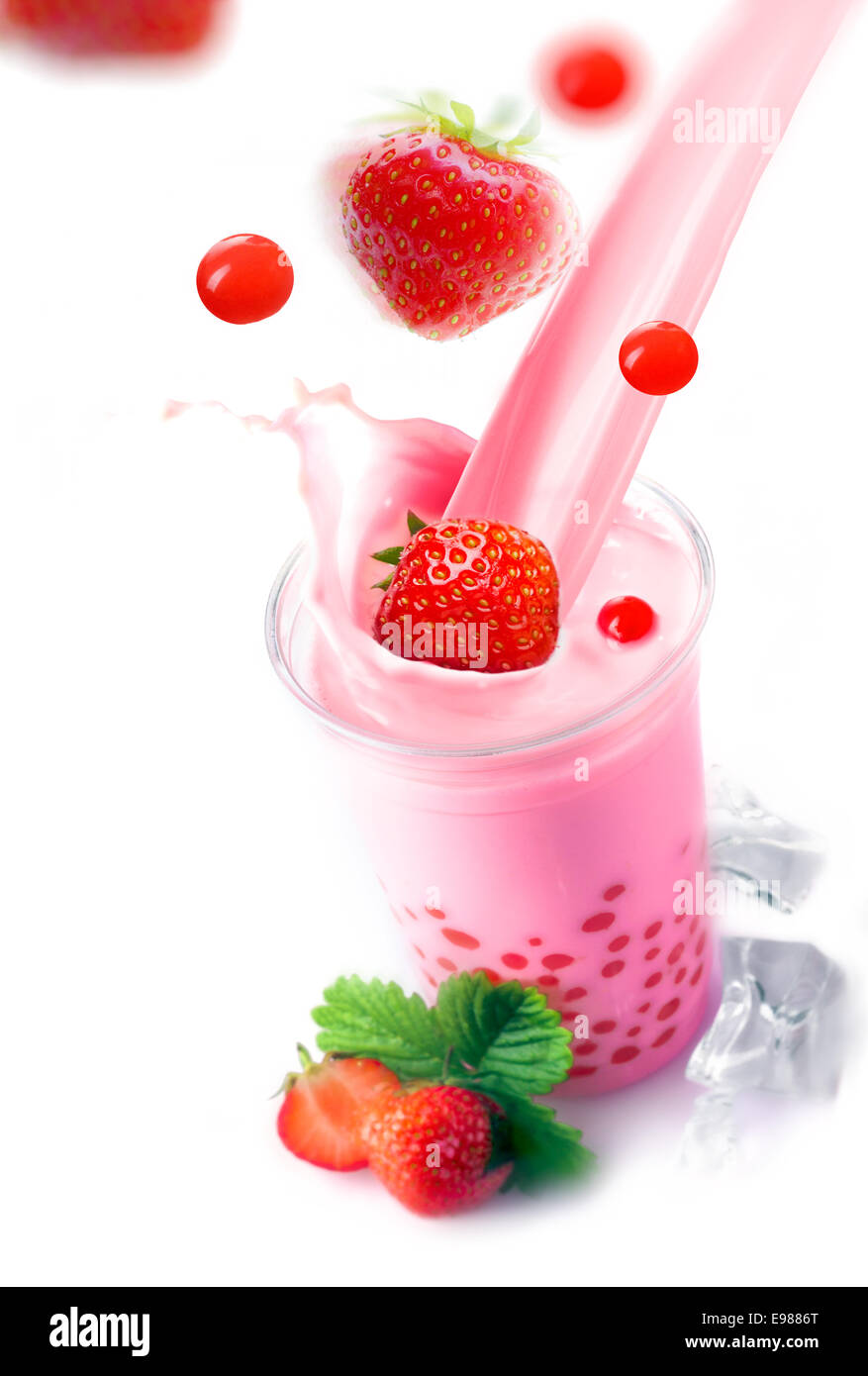 Pouring a glass of healthy strawberry boba or bubble tea with fresh ...