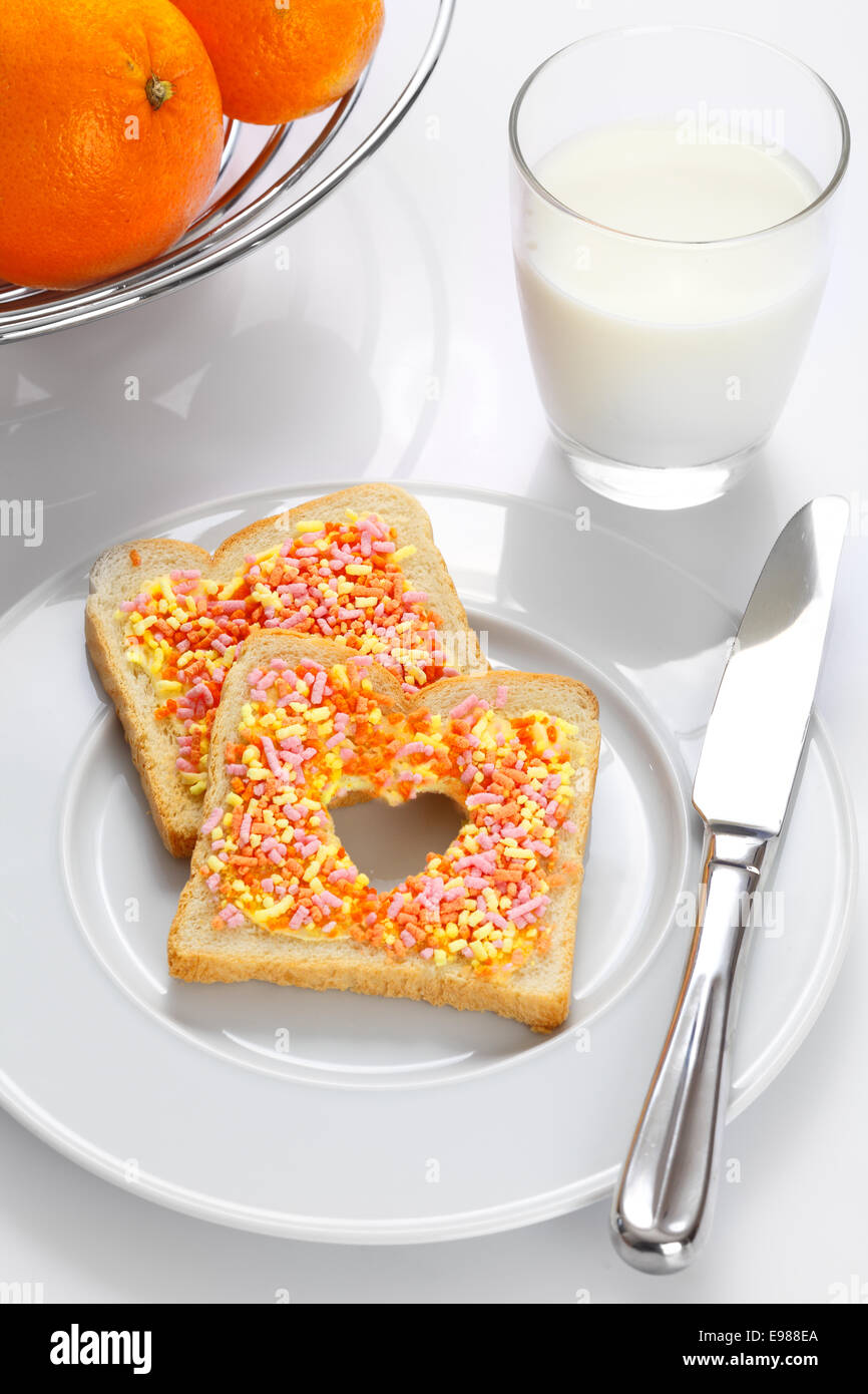 Tasty elegant breakfast made of slices of bread with candies, oranges ...