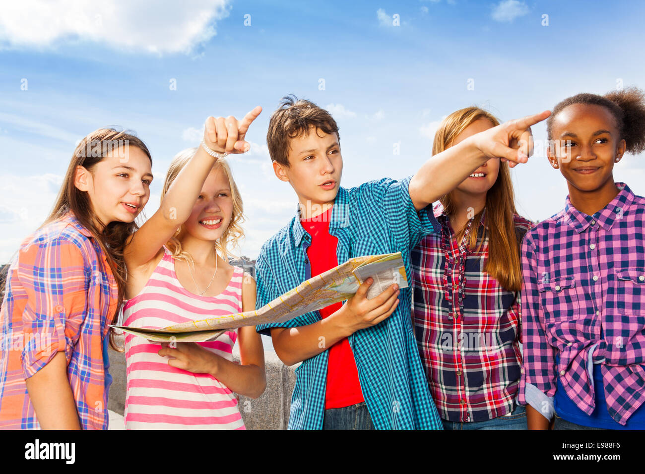 Happy children pointing with map standing close Stock Photo - Alamy Happy children pointing with map standing close Stock Photo - Alamy