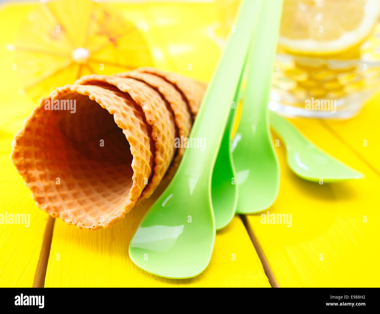 Closeup of a stack of four empty sugar wafer icecream cones with green ...