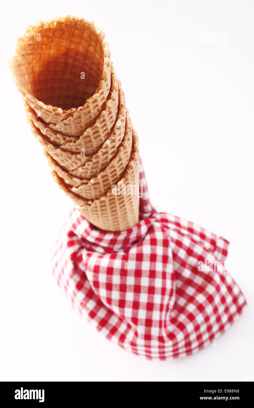 Stacked tower of empty ice-cream cones with a colourful rustic red and ...